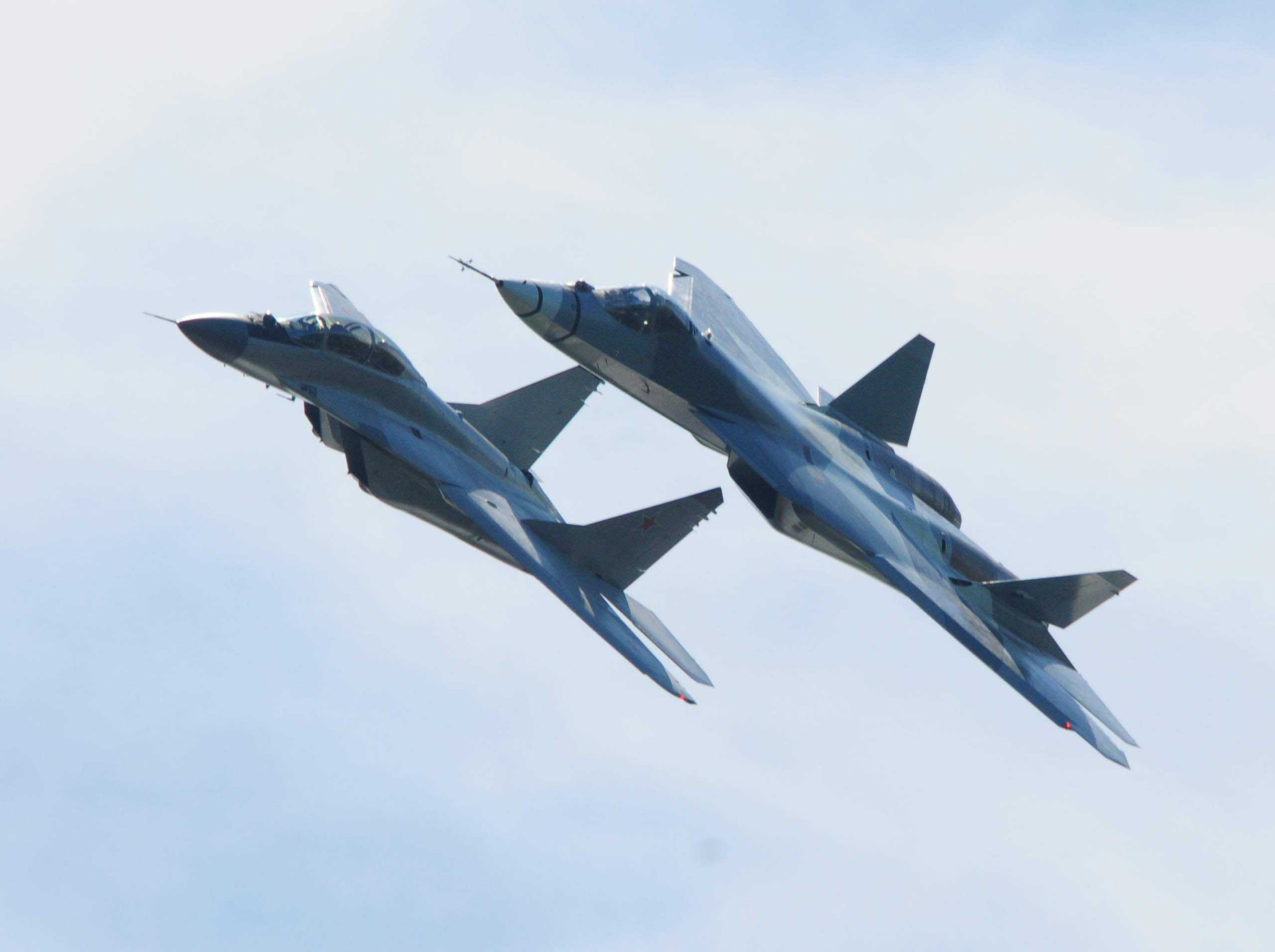 Russian T-50 PAK-FA fifth generation fighter flies alongside the MiG ...