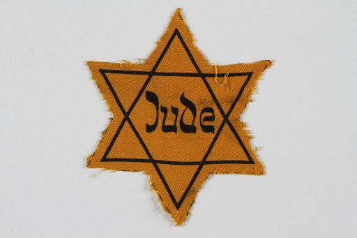 Unused Star of David badge with Jude printed in the center issued to a ...