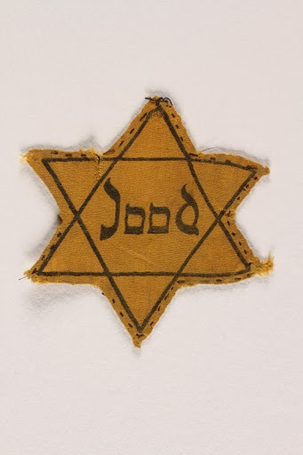 Yellow cloth Star of David badge printed with Jood, Dutch for Jew, worn ...