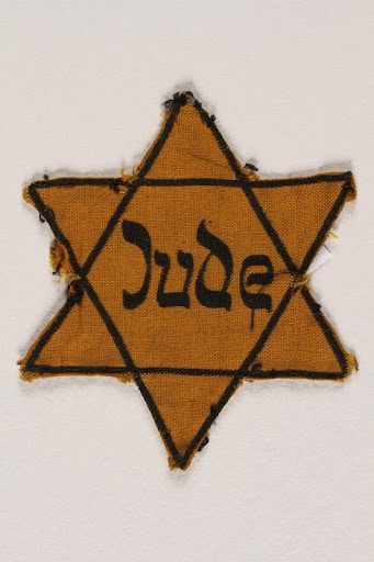 Star of David yellow cloth badge printed with Jude, the German word for ...